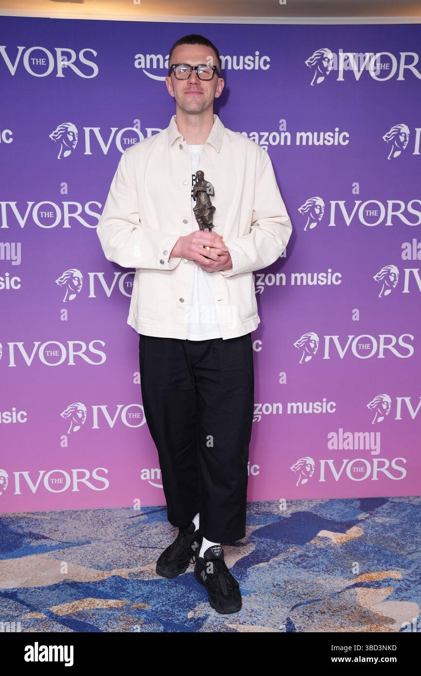 Raffertie, winner of the Best Film Score, poses in the winners' room ...