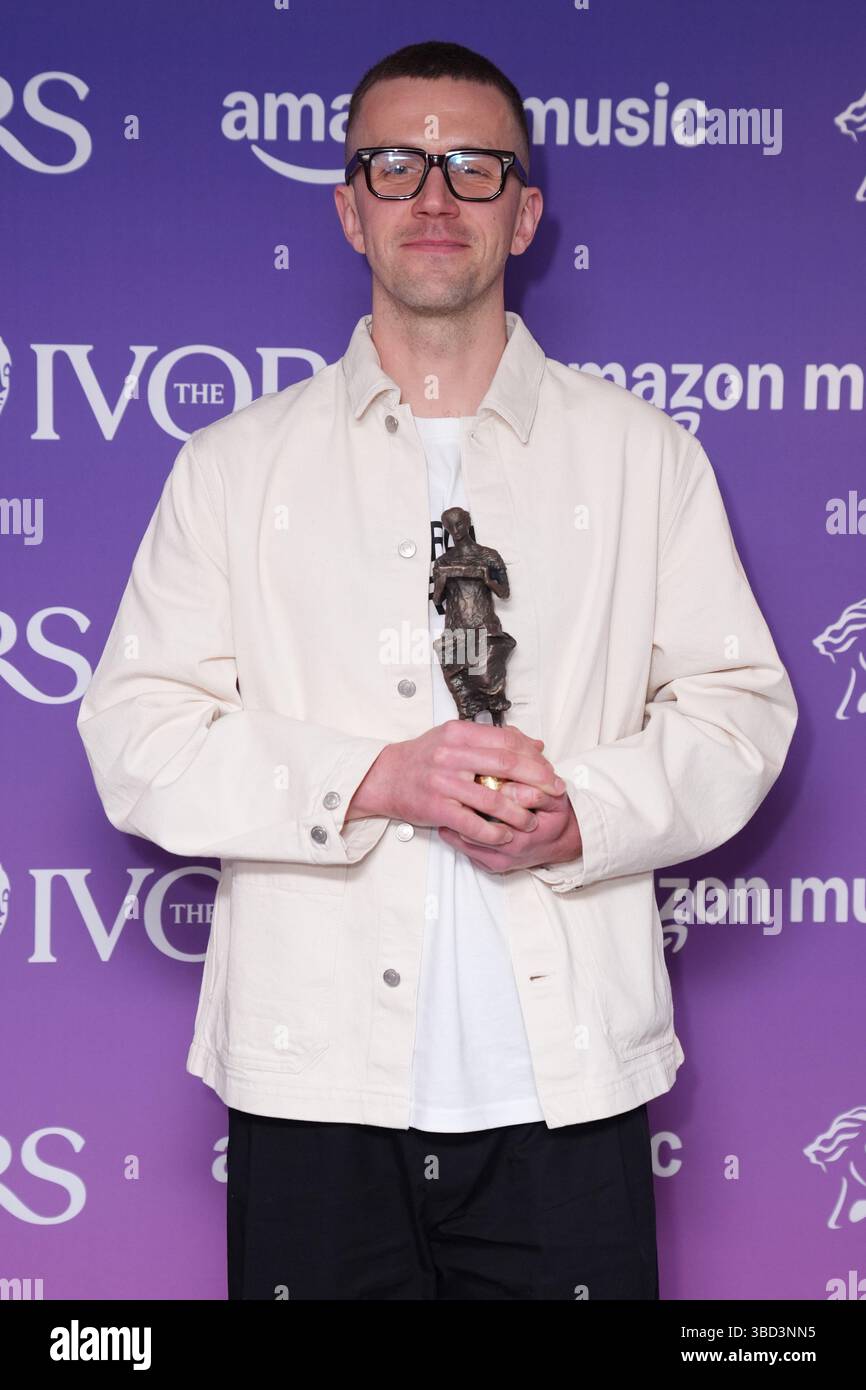 Raffertie, winner of the Best Film Score, poses in the winners' room ...