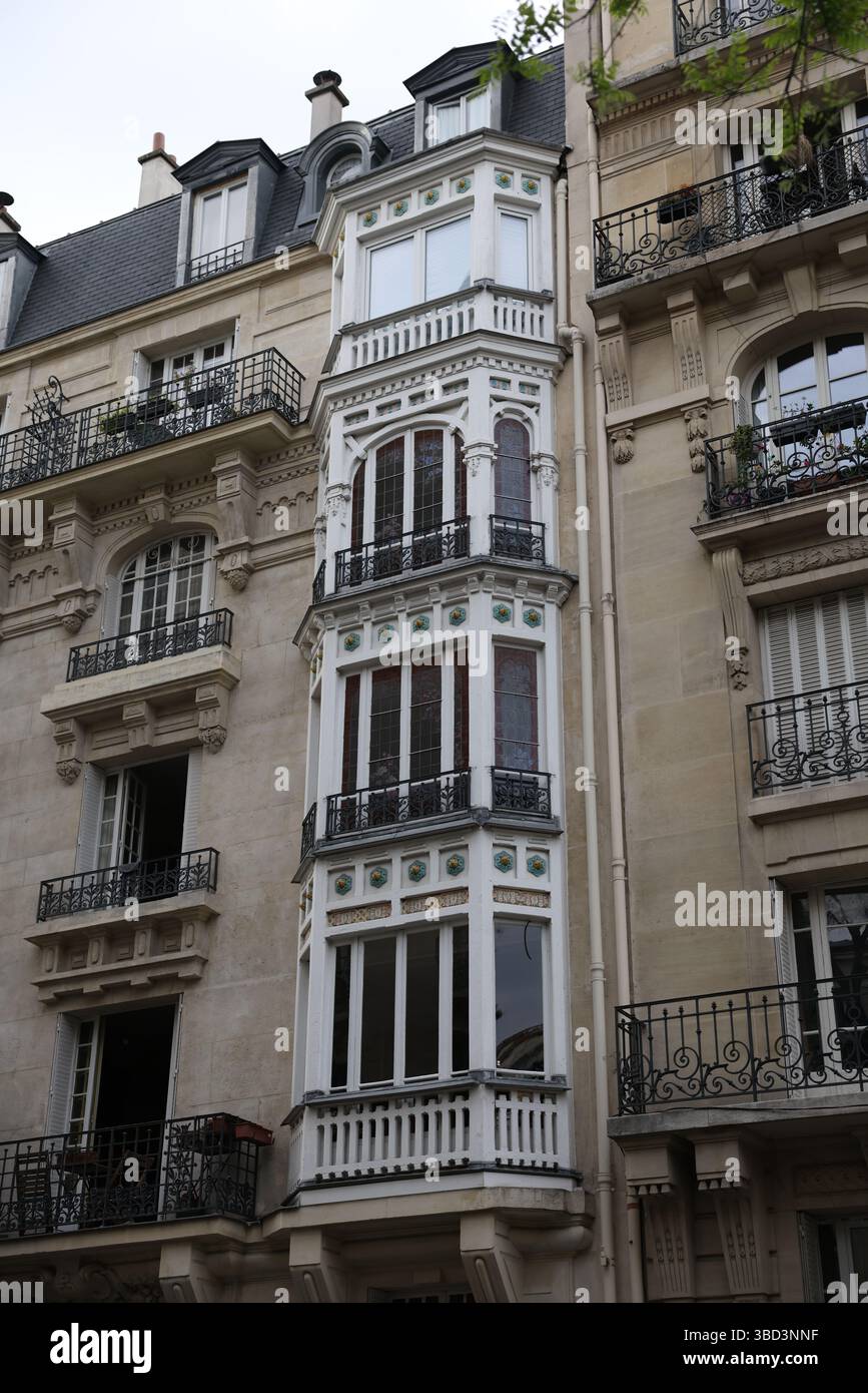 A beautifully crafted multi-story bay window with intricate wrought ...