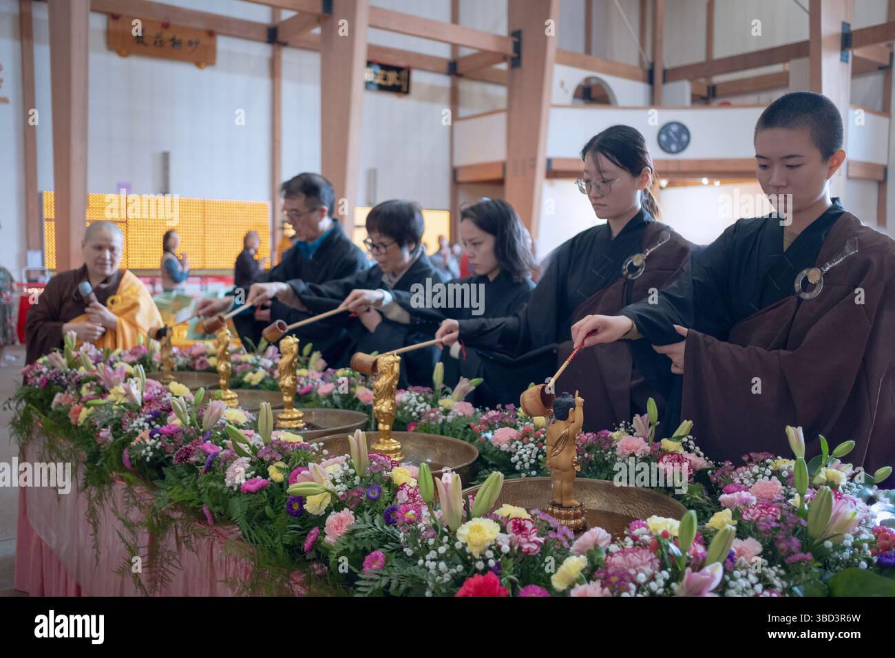 Buddhist nuns pour water over the statue of the Baby Buddha as a symbol ...