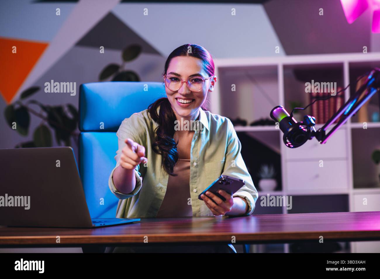 Confident young woman hosting an engaging live streaming session with ...