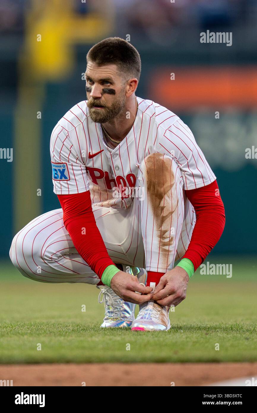 Philadelphia Phillies' Bryce Harper looks on as he ties his cleats ...