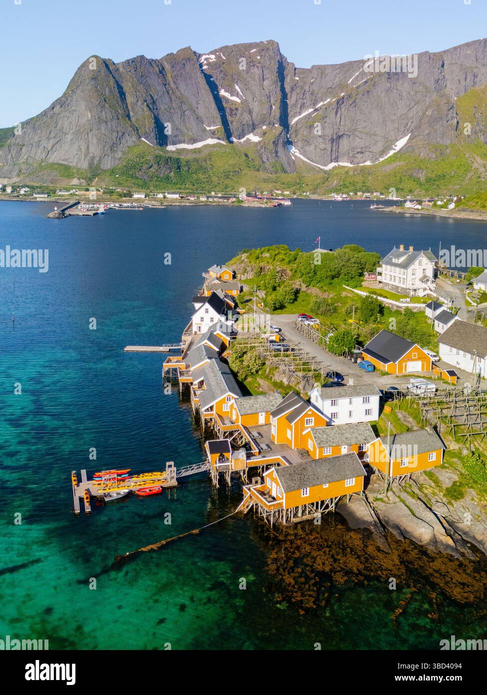 Vibrant yellow cottages nestled along the fjord showcase Norways ...
