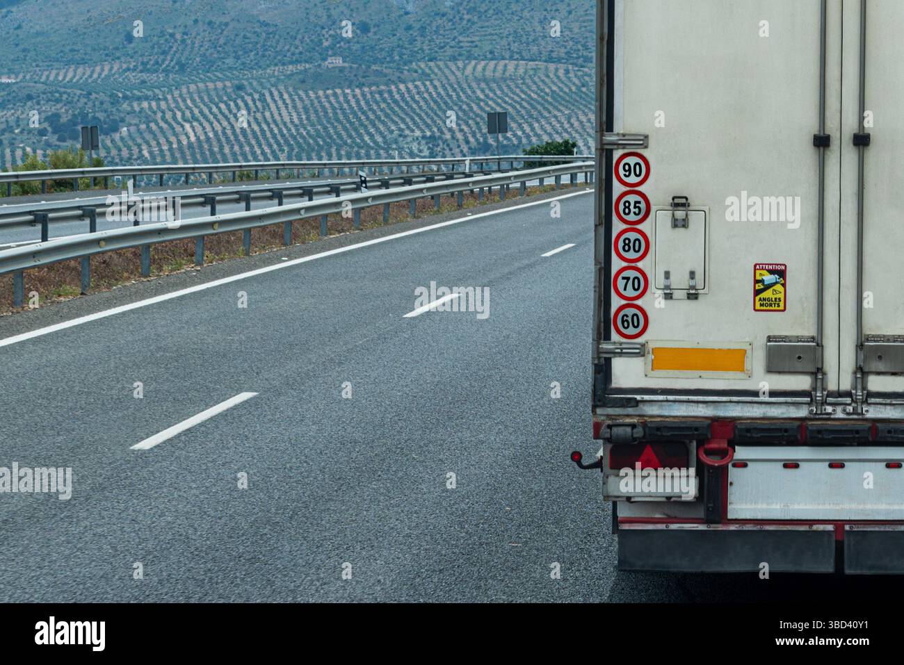 Rear view of a refrigerated truck driving on the highway, displaying ...