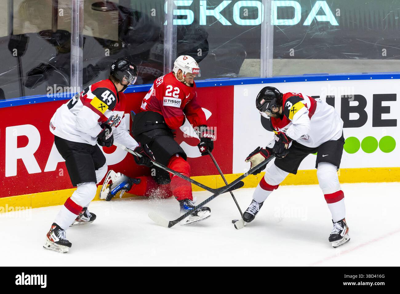 Switzerland's Nino Niederreiter in action with Austria's Gregor Biber, left, and Peter Schneider ...