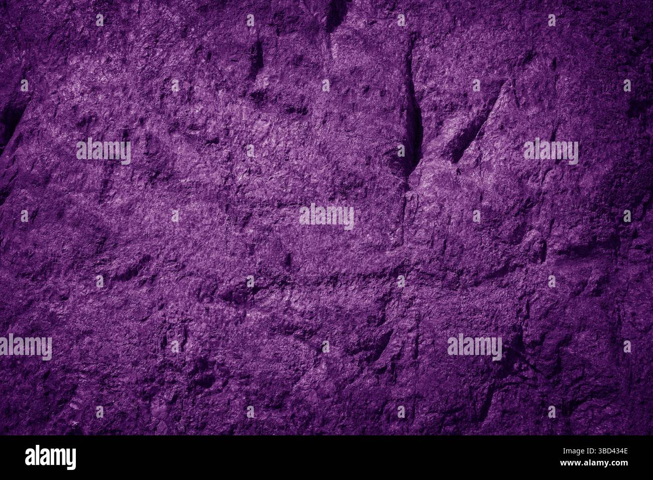Dark, textured stone wall with purple highlights Stock Photo - Alamy