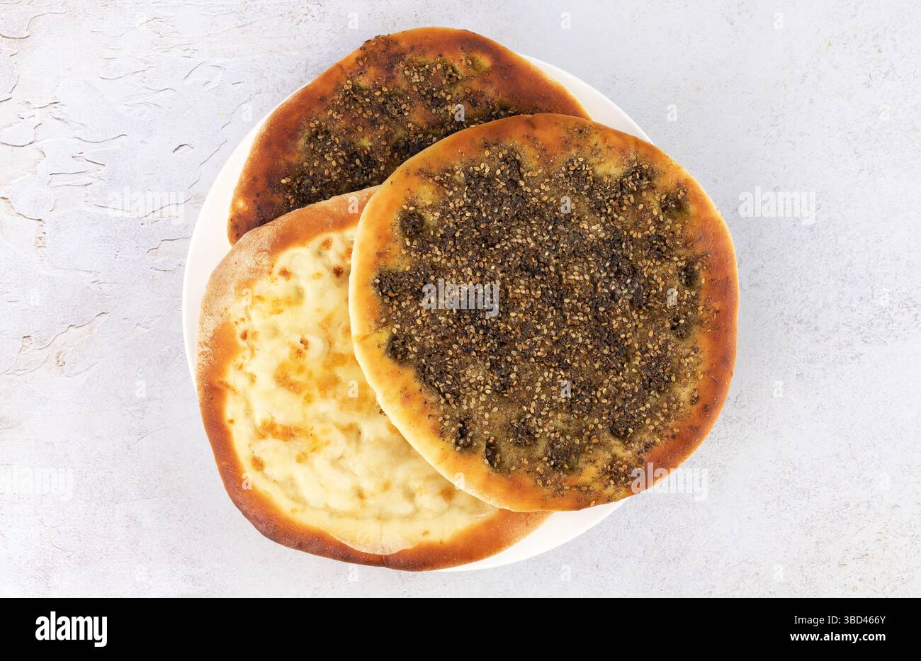 Manakish flatbread with cheese and zaatar spice mix on a light ...
