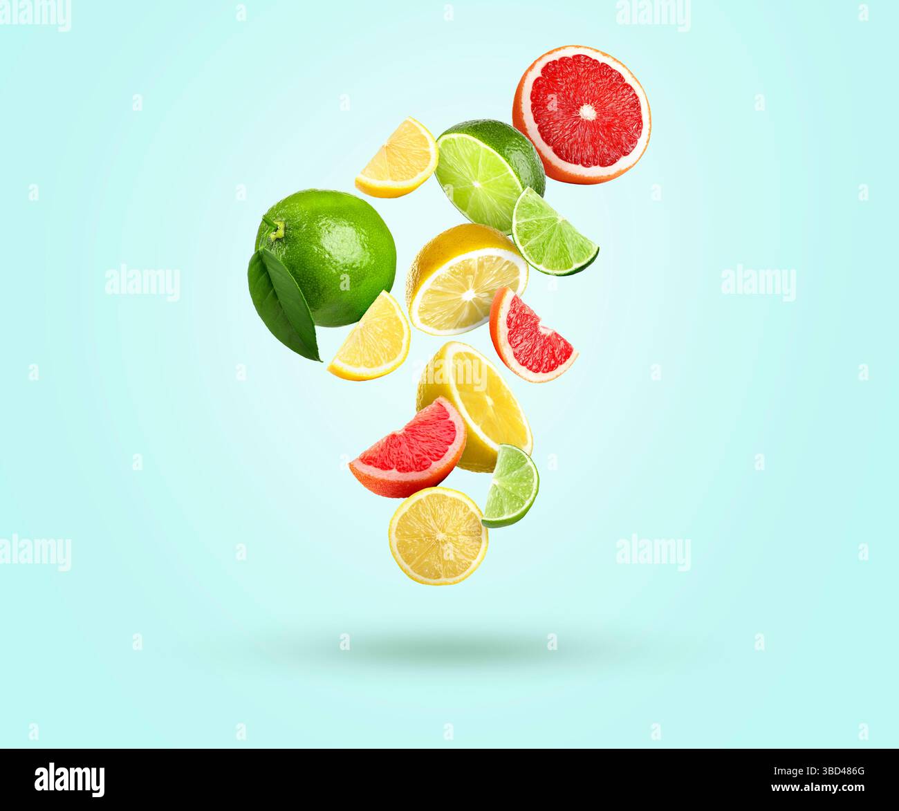 Different fresh citrus fruits falling on light blue background Stock ...