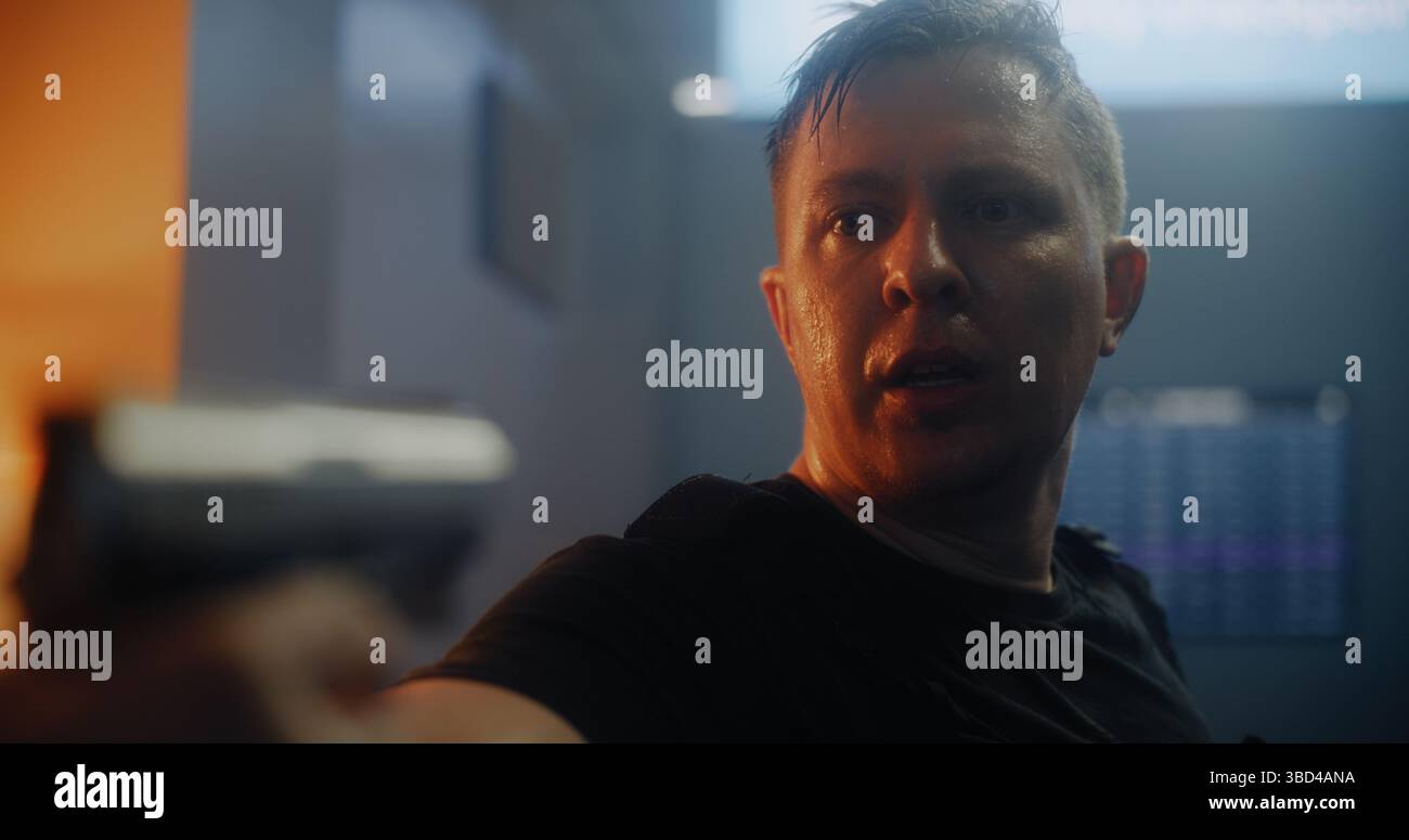 Close Up of Agent in Black Tactical Clothing Breathing Heavily, Aiming ...