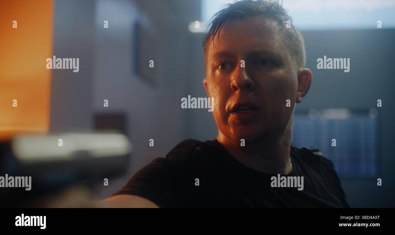 Close Up of Agent in Black Tactical Clothing Breathing Heavily, Aiming ...