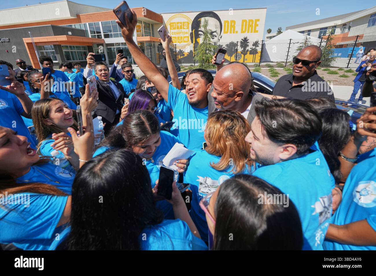 Dr. Andre Dre is hugged by students as he arrives to a ribbon-cutting ...