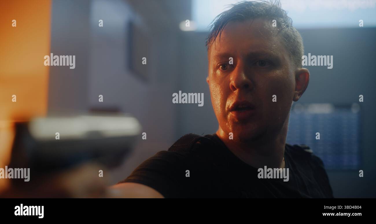 Close Up of Agent in Black Tactical Clothing Breathing Heavily, Aiming ...