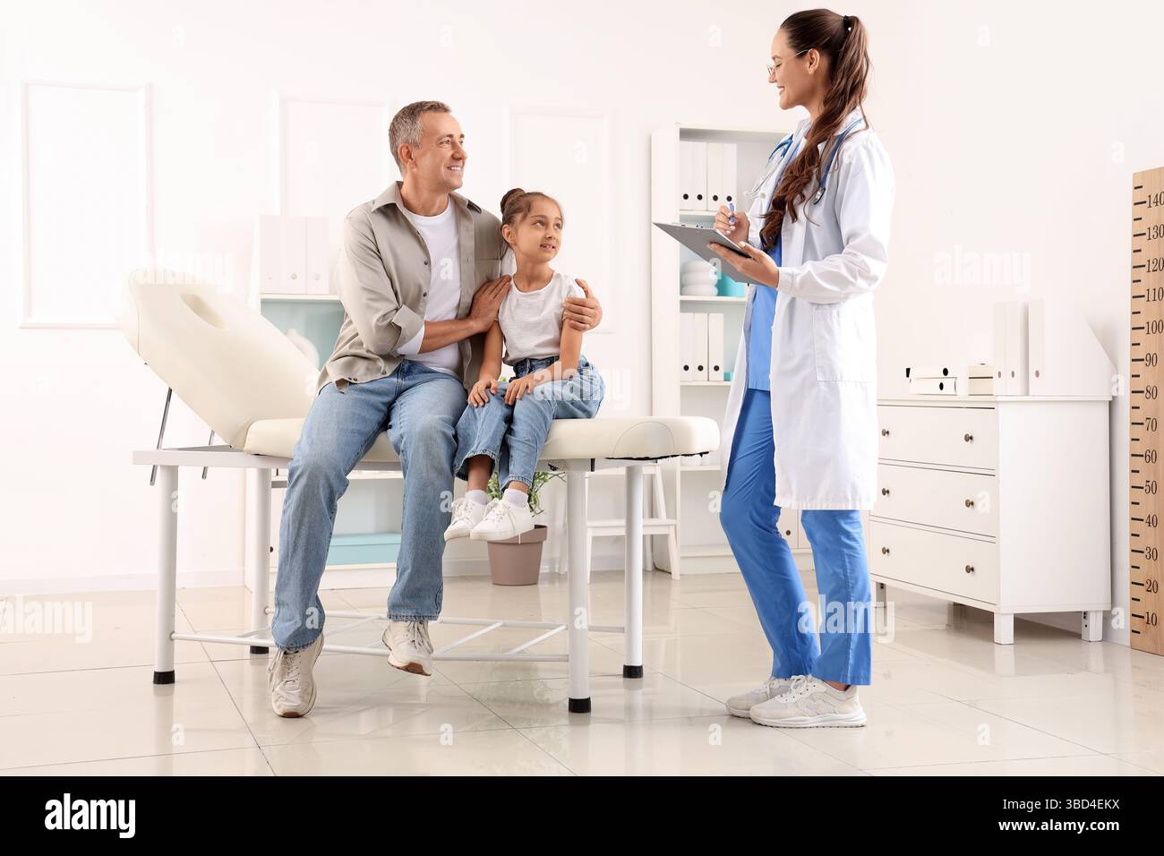 Little girl with her father visiting pediatrician in clinic Stock Photo ...