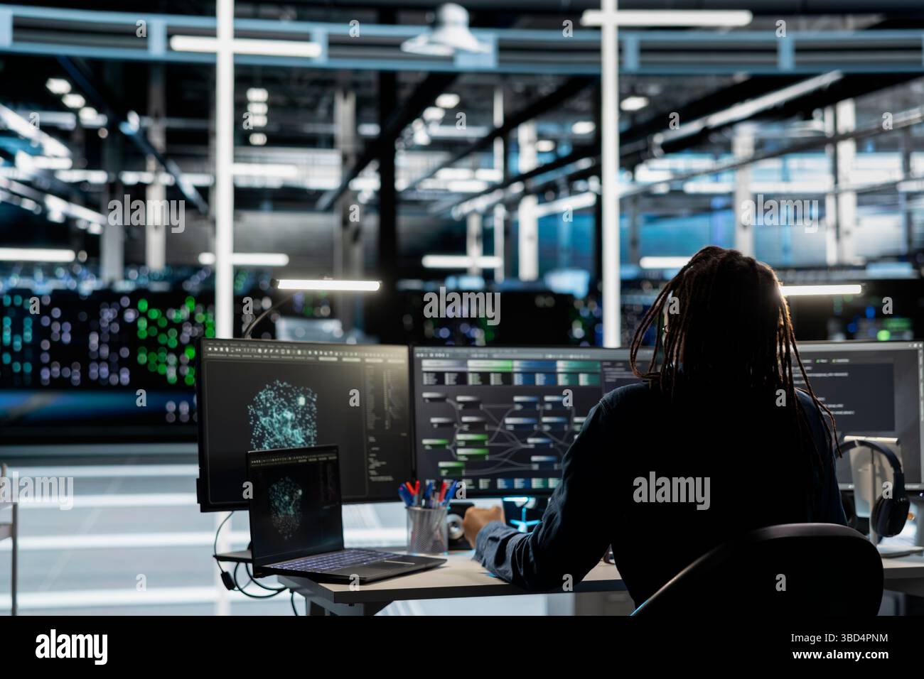 Server farm IT professional looks at data analysis graph to reduce infrastructure failure. Data ...