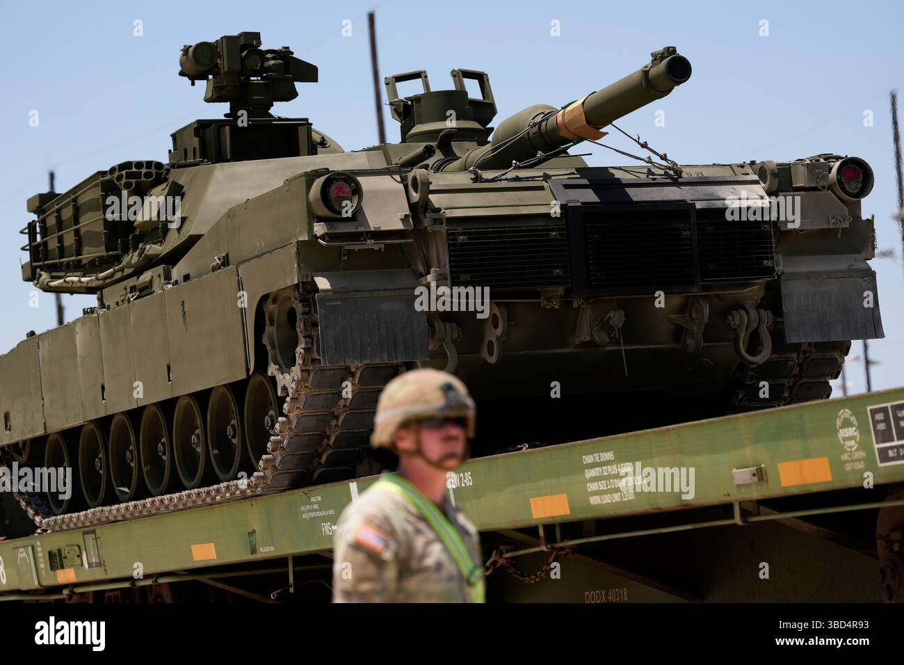U.S. Army personnel load and secure military tanks for transport to ...