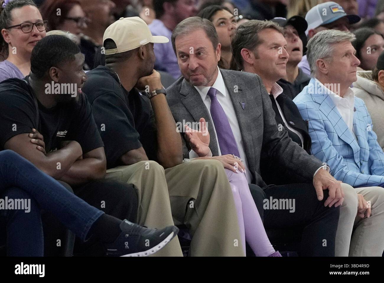 Golden State Warriors forward Jonathan Kuminga, left, talks with owner ...