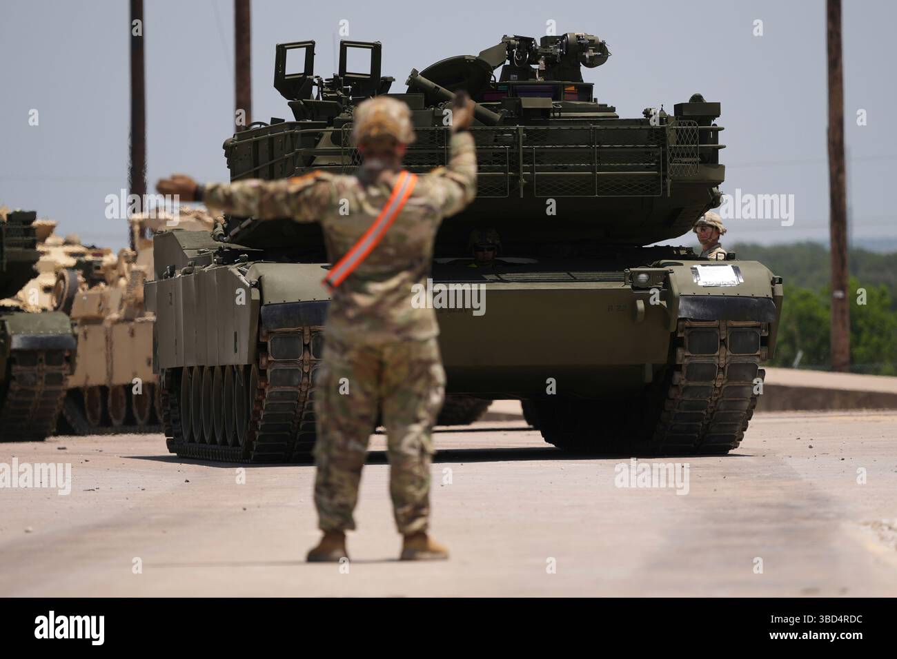 U.S. Army personnel load and secure military tanks for transport to ...