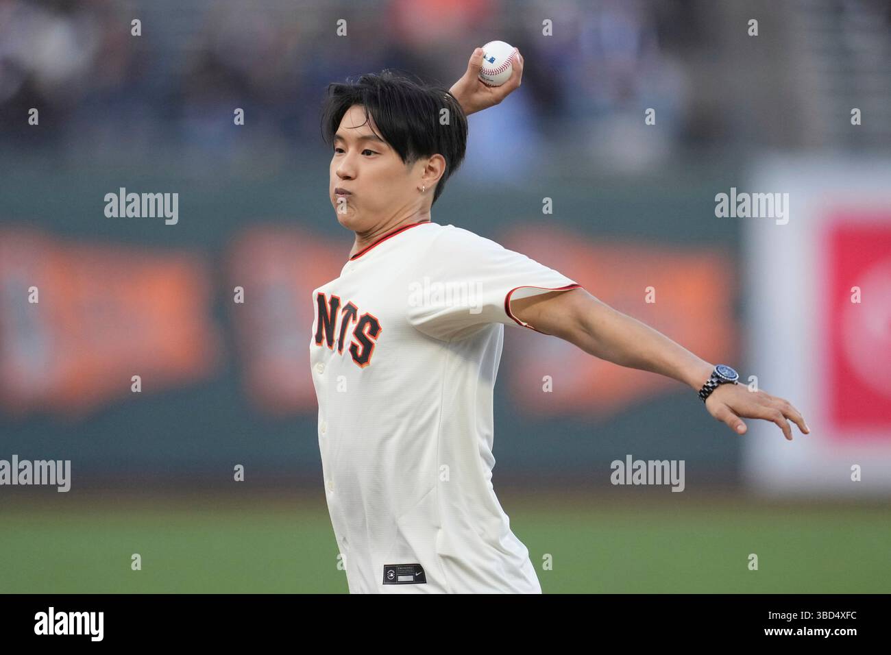 Musician sunkis is shown throws a ceremonial first pitch before a ...
