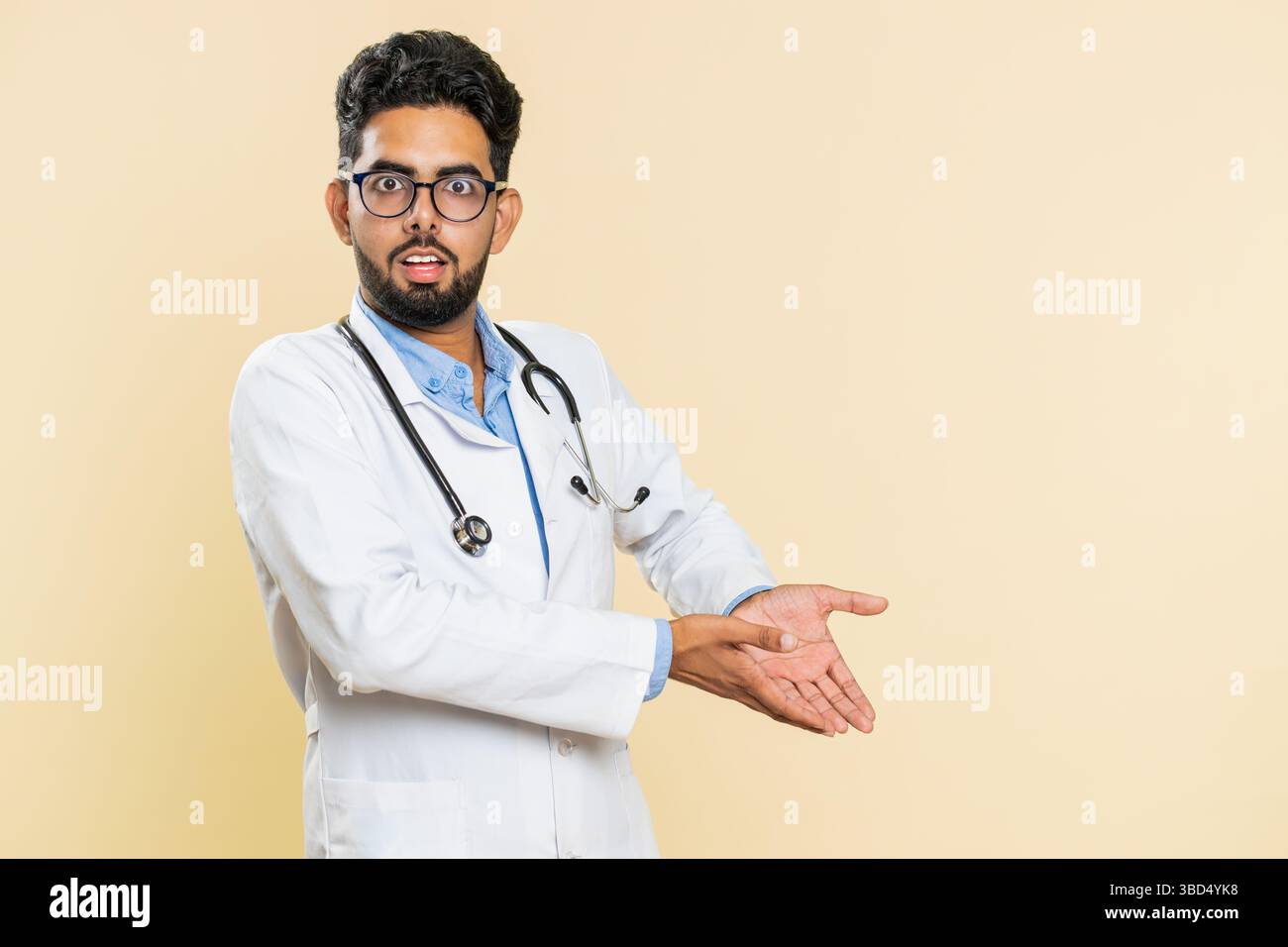 Indian young doctor cardiologist man raising hands asking what why ...