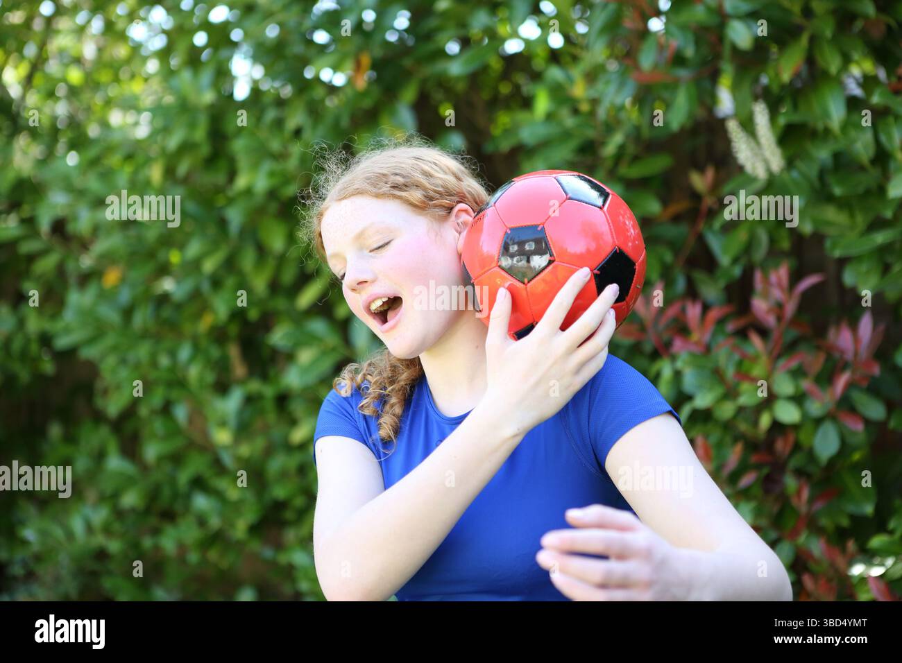 Girl balances football on shoulder soccer balance skill female Stock ...