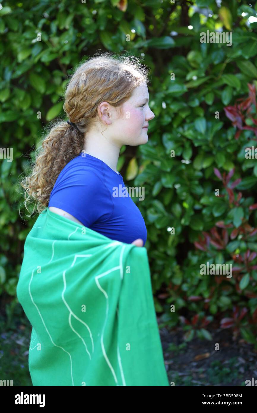 Girl holding green football cloth pitch around shoulders arms football ...