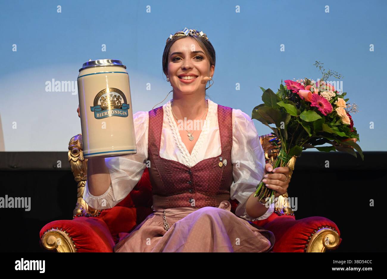 Munich, Germany. 22nd May, 2025. Beer Queen Anna Winkler sits on a ...