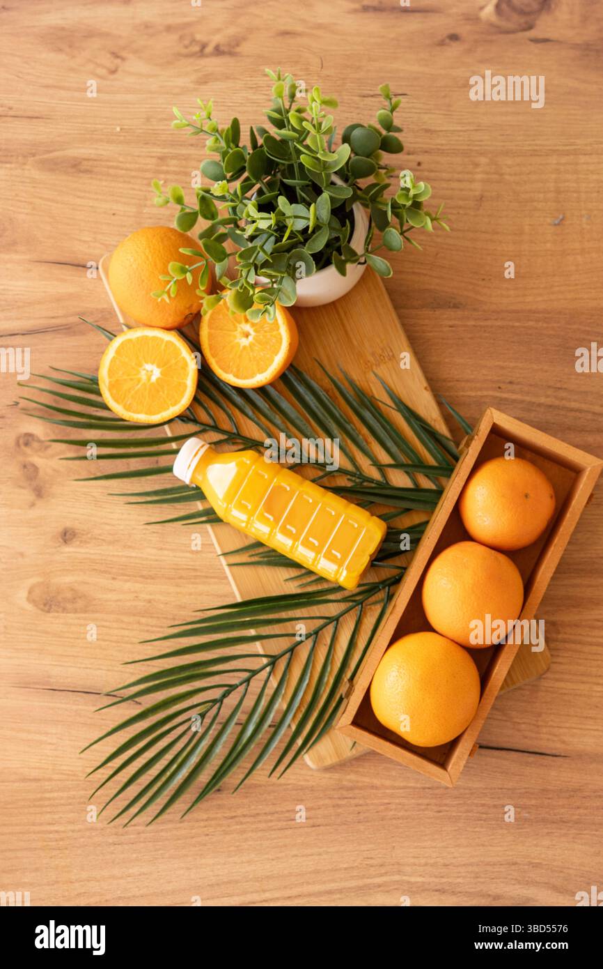 Top-down vibrant still life featuring fresh oranges in a wooden crate ...