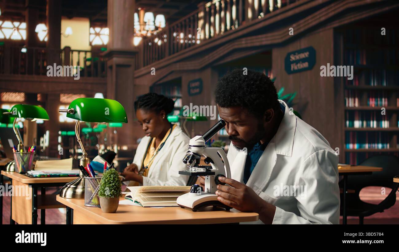 African American pupil studies microbiology in a campus library ...