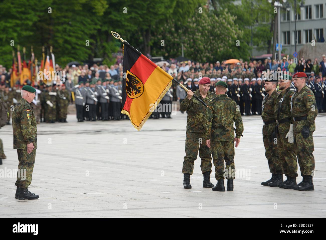 Members of the German armed forces hand over a Bundeswehr command flag ...