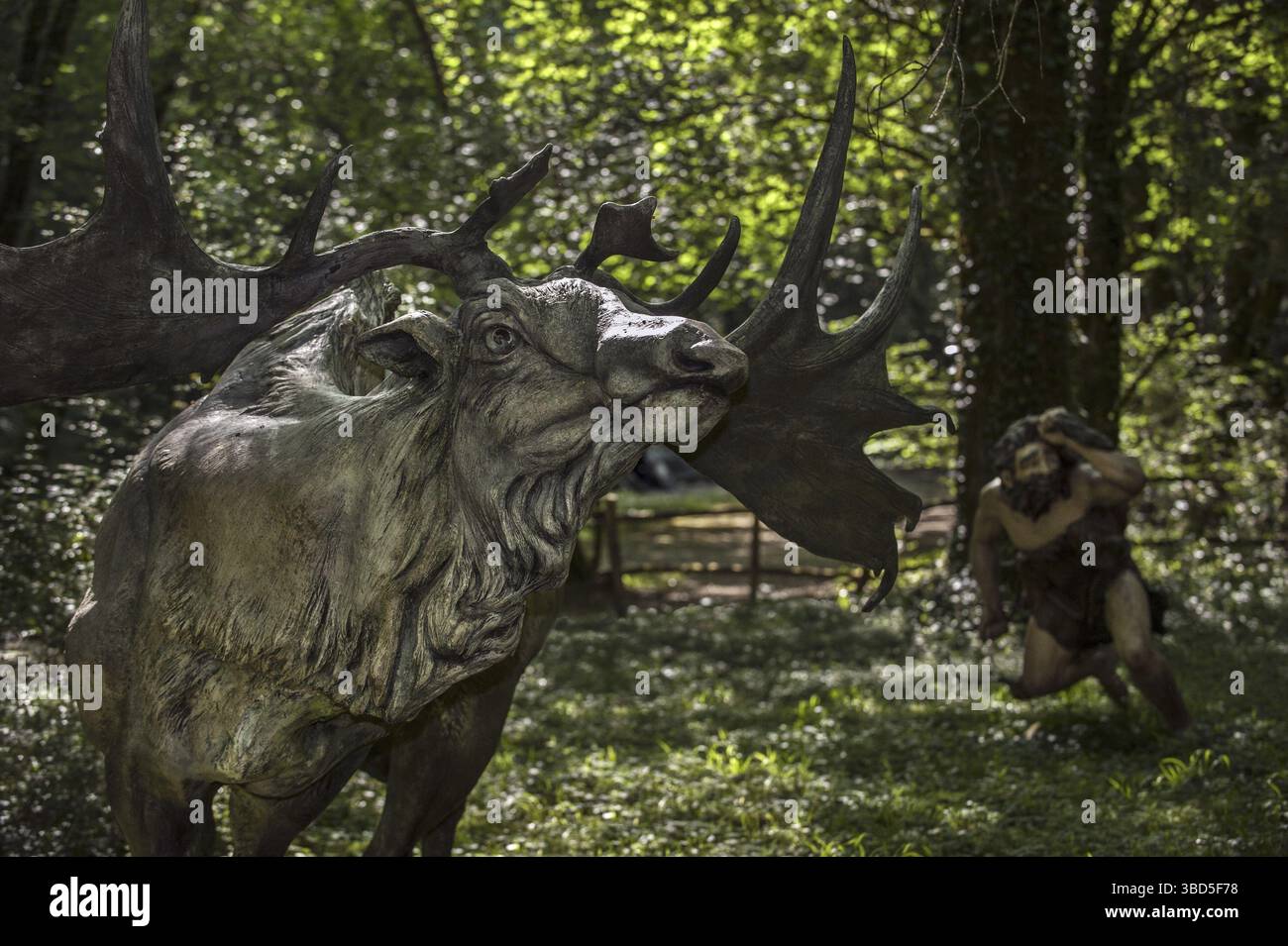 Diorama showing Neanderthal hunter chasing Irish elk (Megaloceros ...