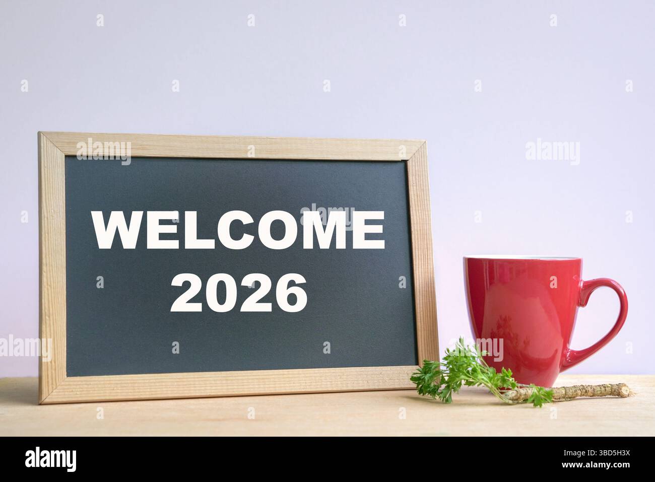 Welcome 2026, on chalkboard next to red coffee cup Stock Photo - Alamy