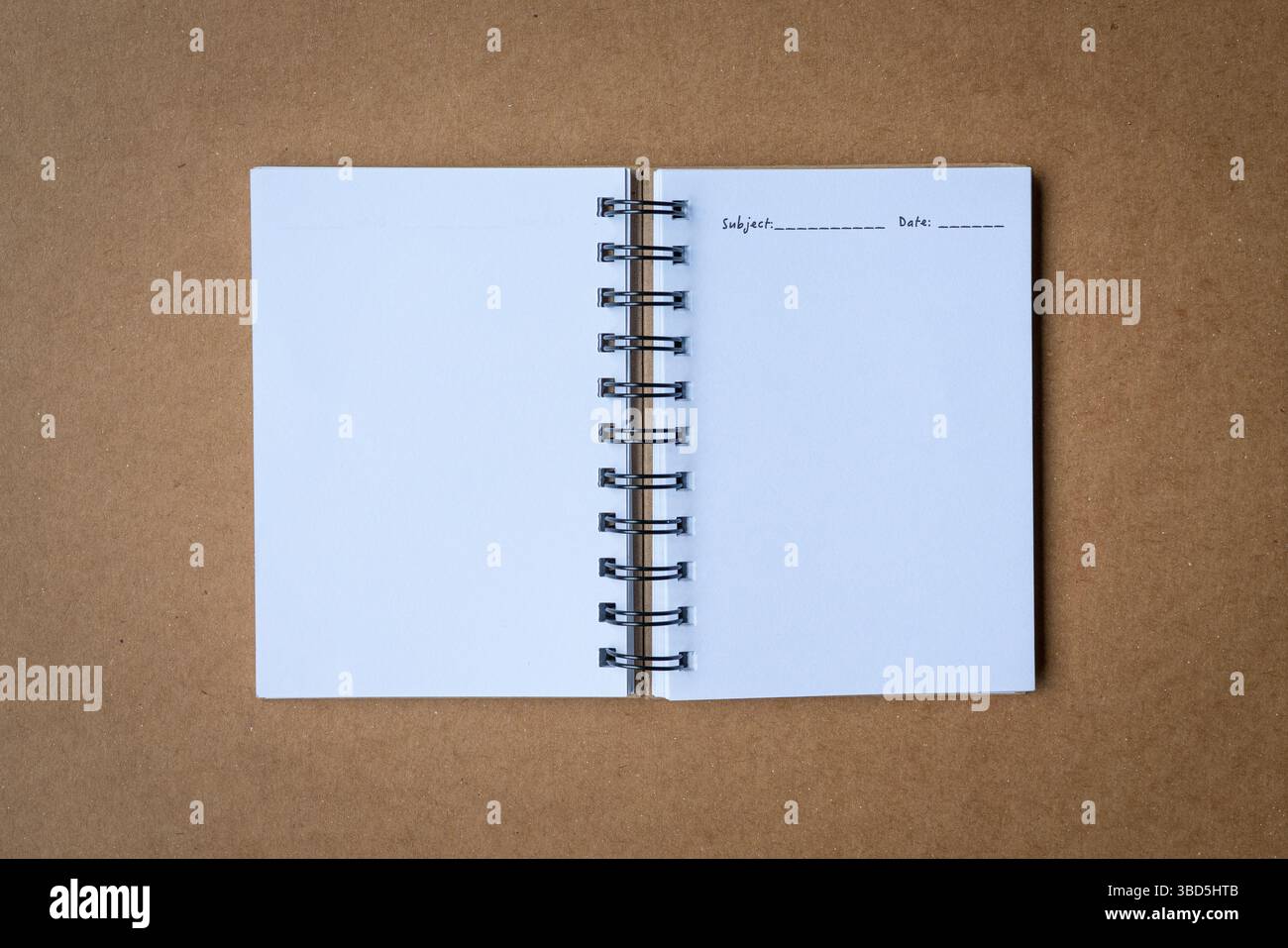 Open white journal notebook, top view. Isolated on brown cardboard ...