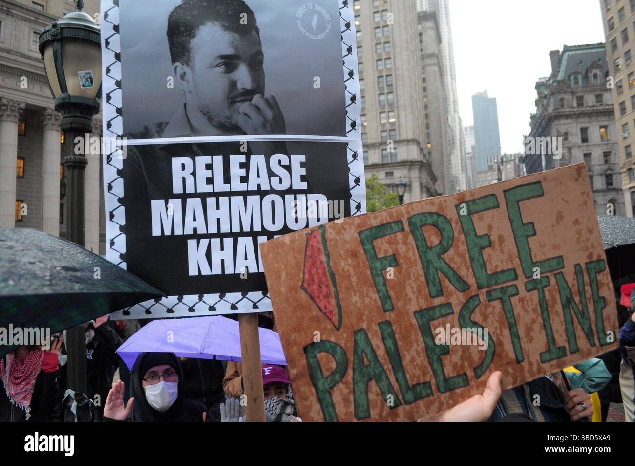 A pro-Palestine demonstrator holds a placard of Mahmoud Khalil at a ...