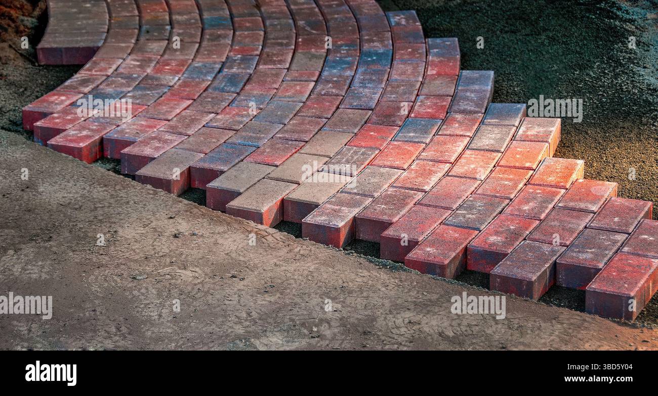 Brick pavers arranged in a curving pattern during construction to offer ...