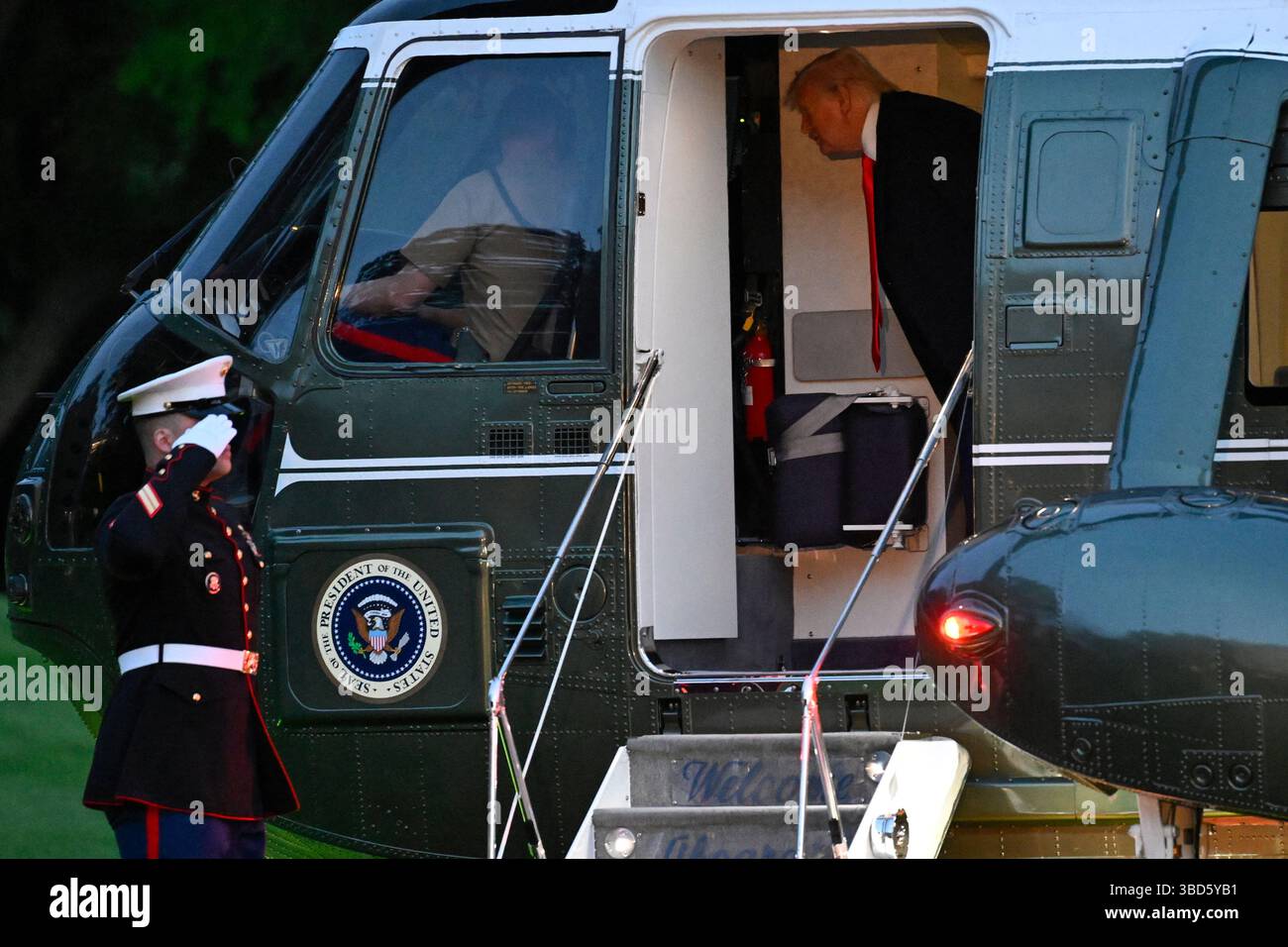President Donald Trump talks to the Marine One pilots after he arrives ...
