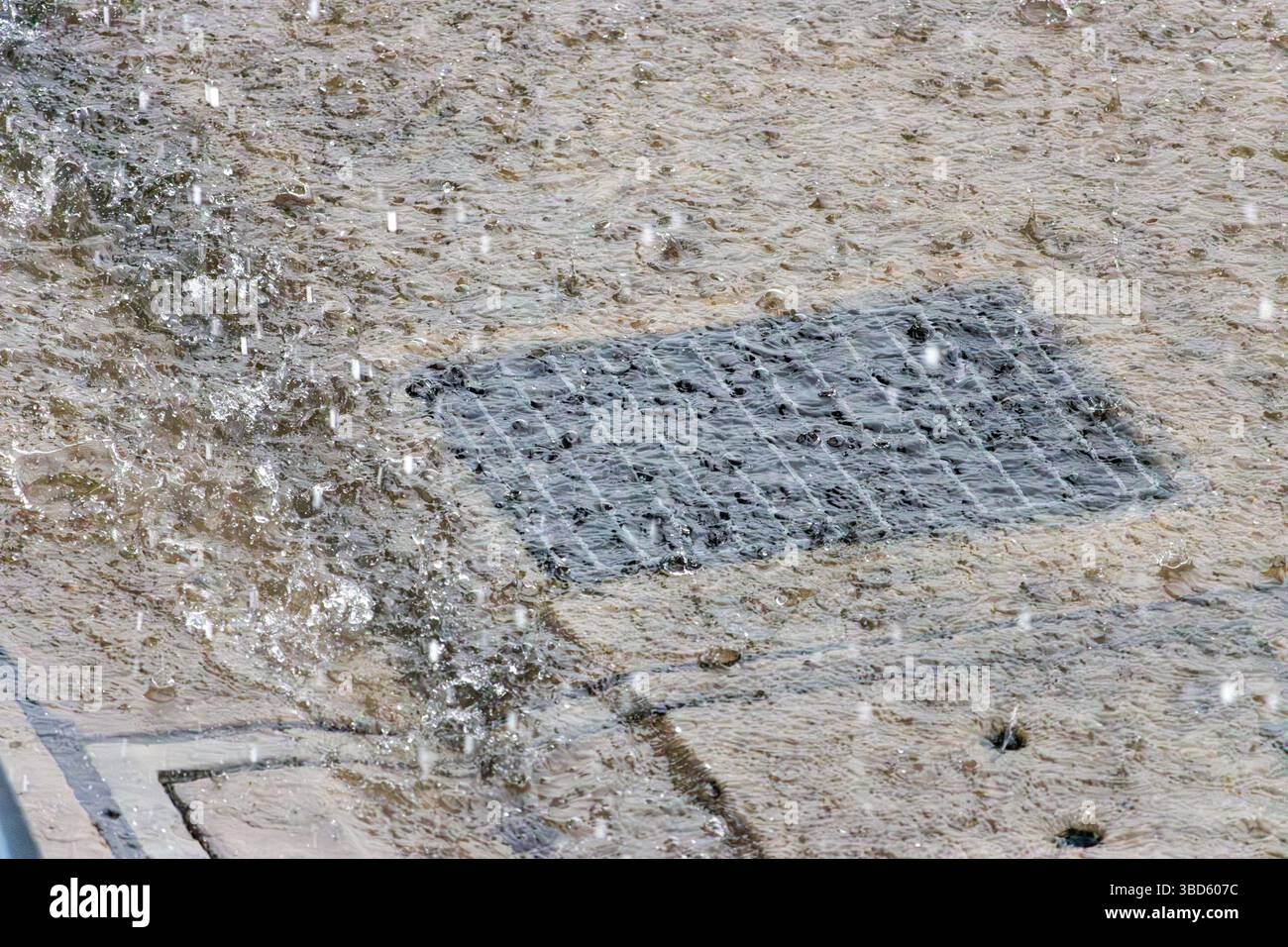Heavy rainfall flood a stormwater drain on an urban road surface Stock ...