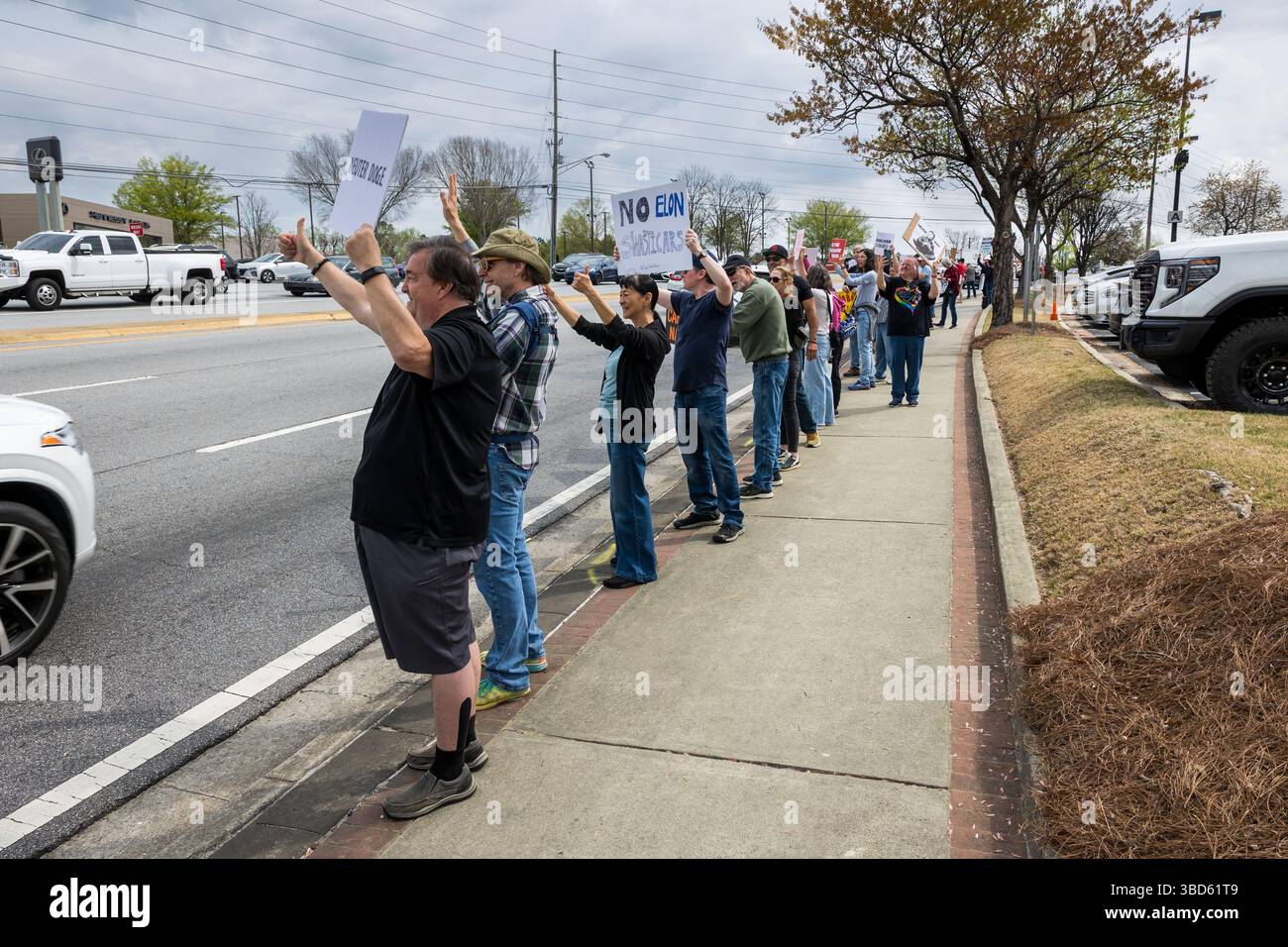 Duluth, GA / USA - March 29, 2025: Dozens of protesters display anti ...
