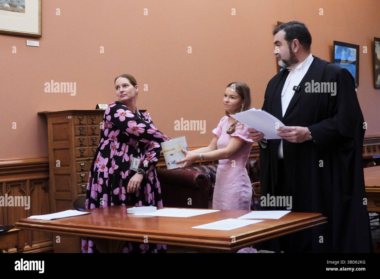 Parliamentary Service staffer Renee Beeson, left, draws a bingo token ...