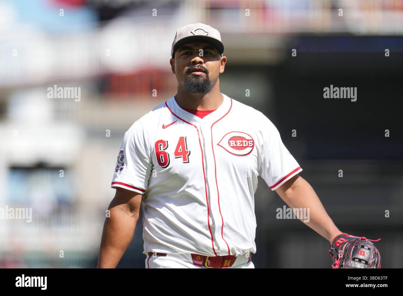 Cincinnati Reds pitcher Tony Santillan (64) walks to the dugout during ...