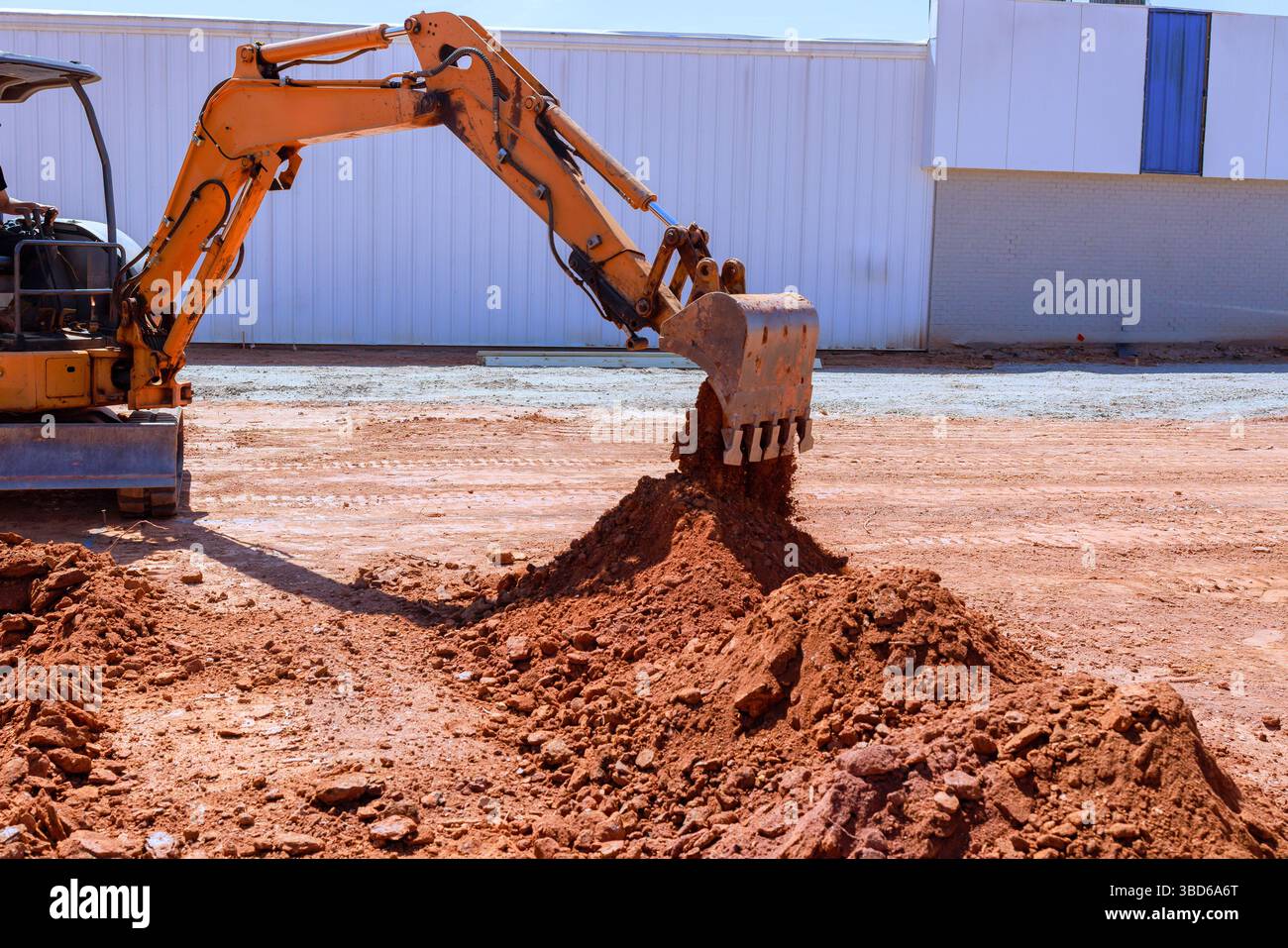 Excavator operates efficiently at construction site, digging earth for ...