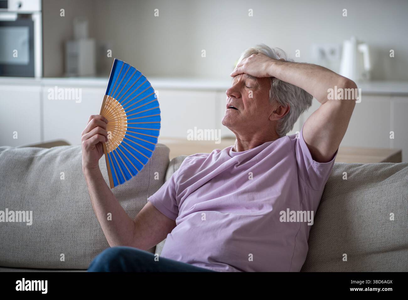 Annoyed elderly man fanning himself sweat dripping no air conditioning ...