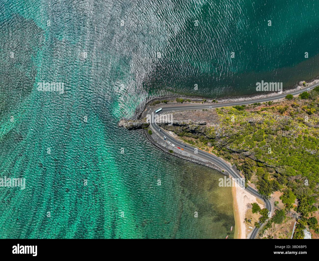 Top down aerial view of the emerald Indian Ocean meeting cliffs and ...