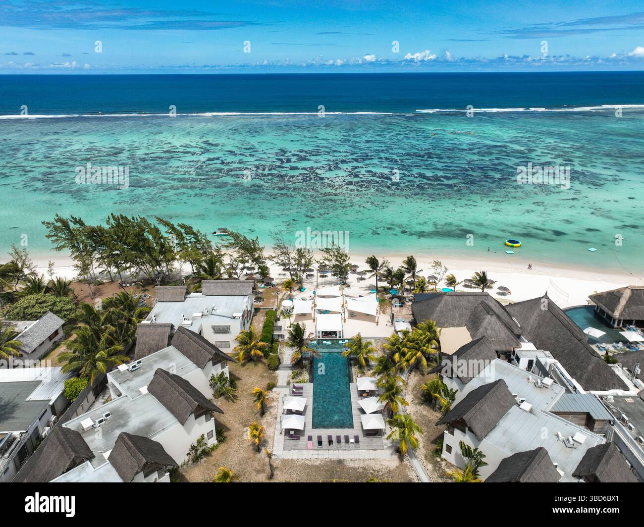 Drone view of beach hotel in Mauritius with long pool facing the lagoon ...