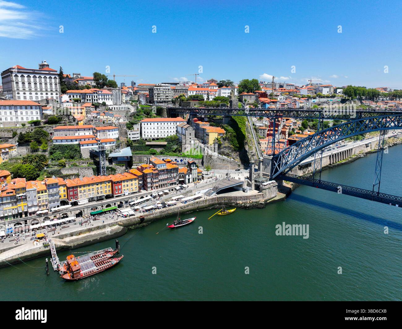 Aerial view of colorful riverside buildings and Dom Luís I Bridge in ...