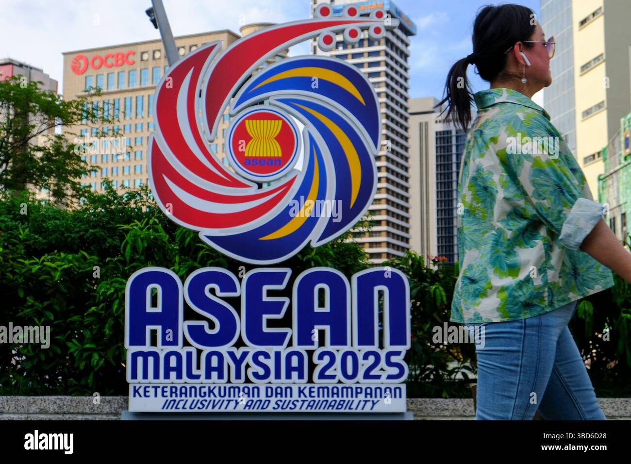Kuala Lumpur, Malaysia. 22nd May, 2025. A woman seen passing by a decoration of the 46th ASEAN ...