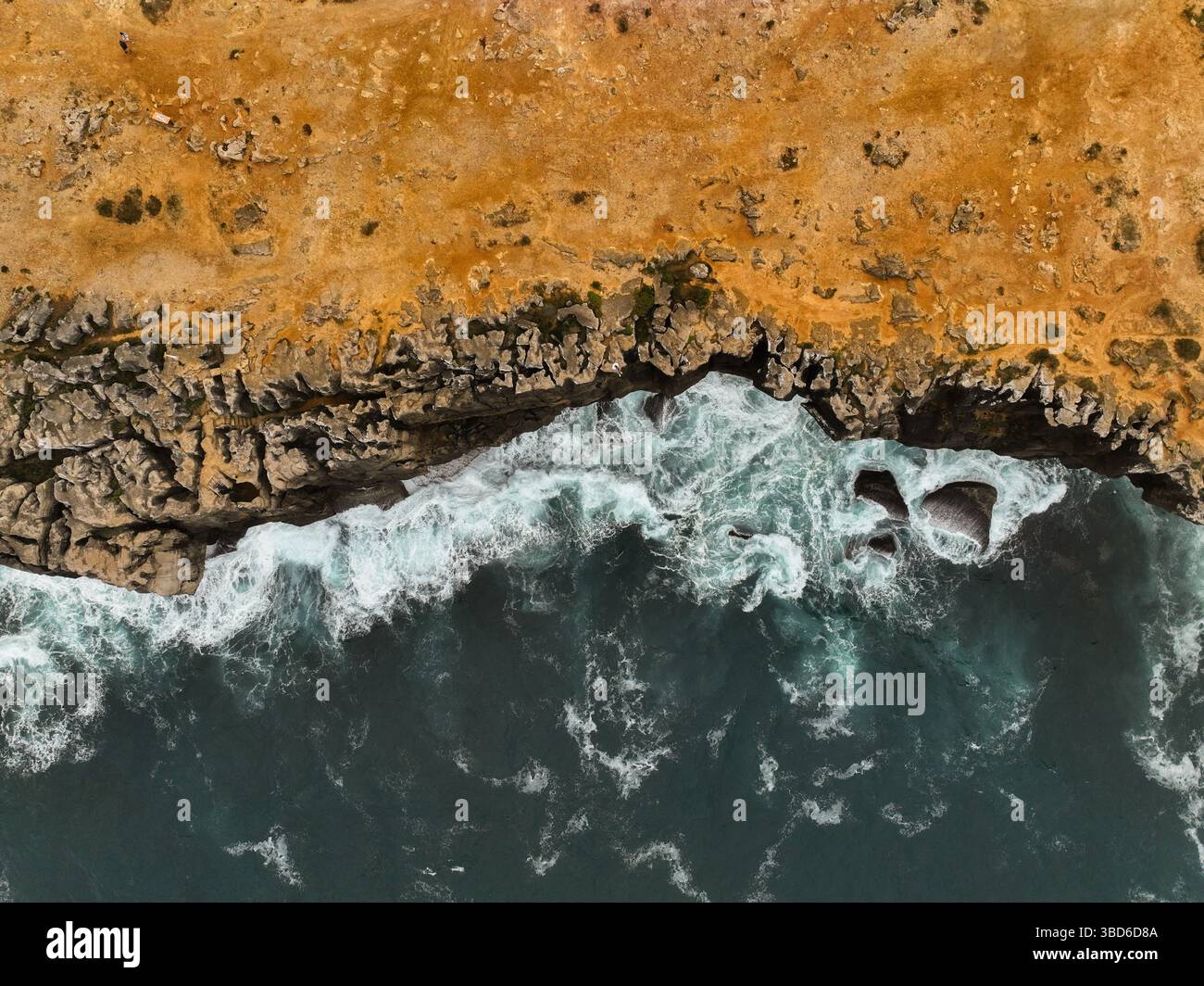 Aerial top-down view of jagged coastal cliffs and Atlantic surf along ...