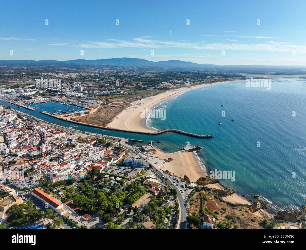 Wide aerial view of Lagos marina, town center, and expansive Meia Praia ...