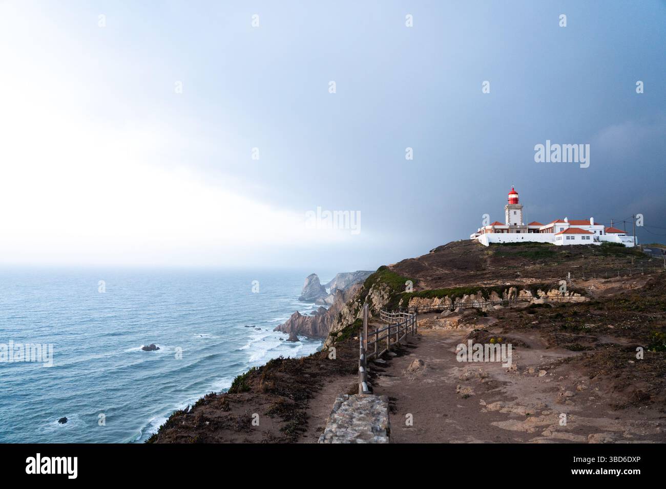Rugged cliff path leading to Cabo da Roca lighthouse as daylight fades ...