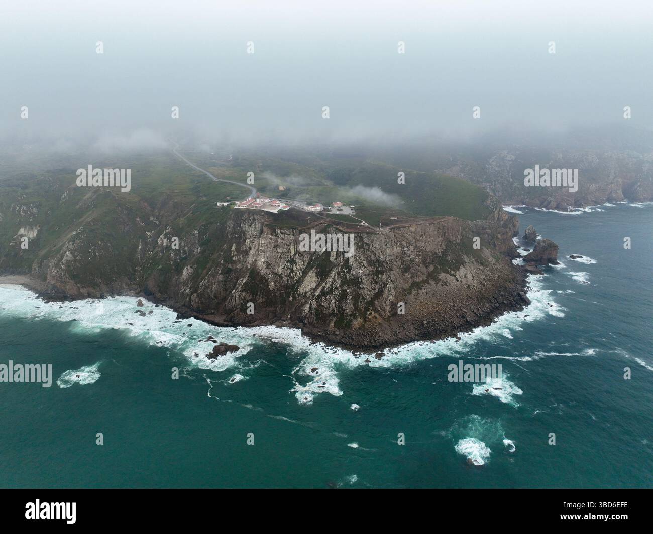 Wide drone image of lighthouse at edge of steep cliffs and turbulent ...