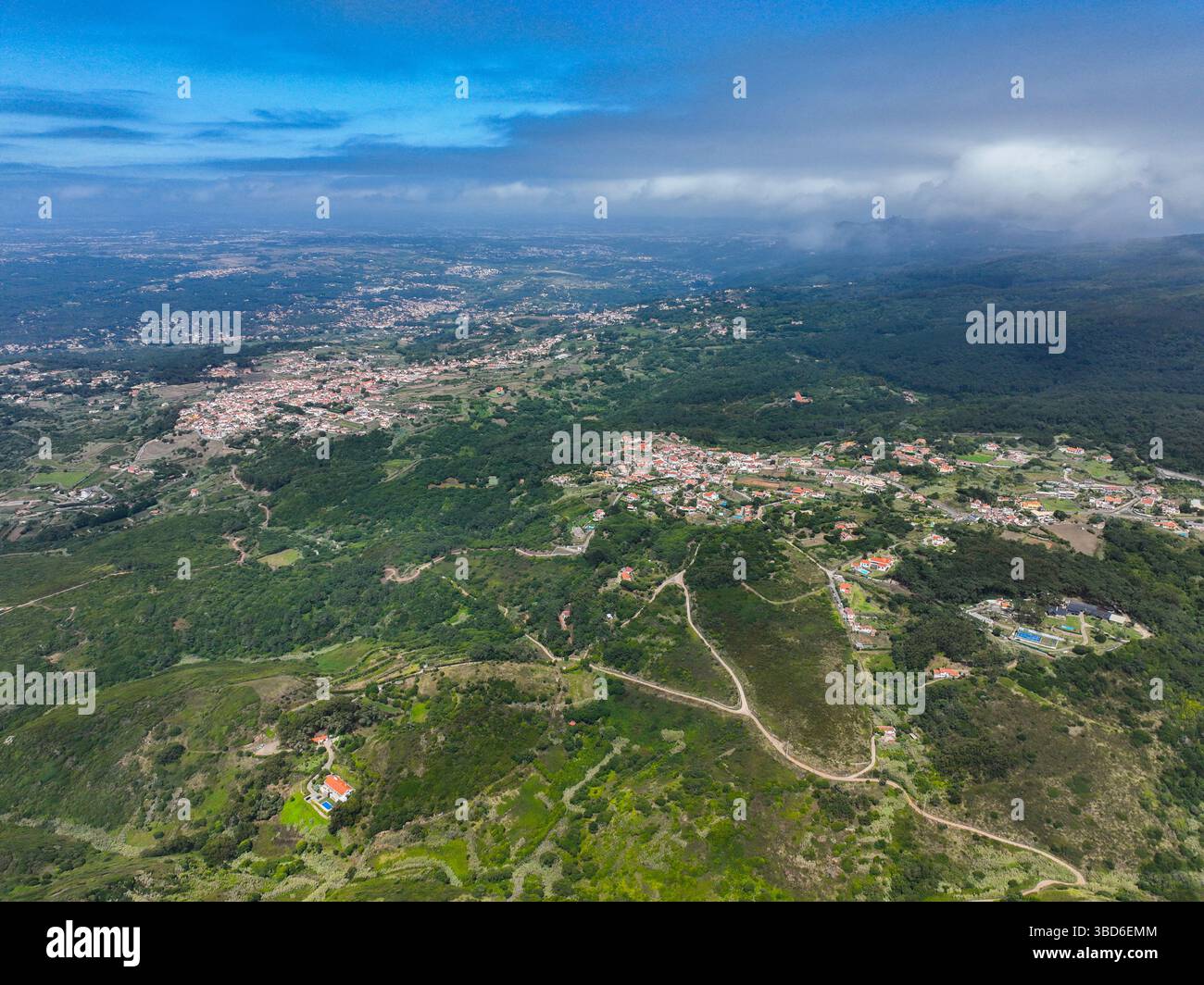 Elevated view showing Azóia village surrounded by lush hills and ...